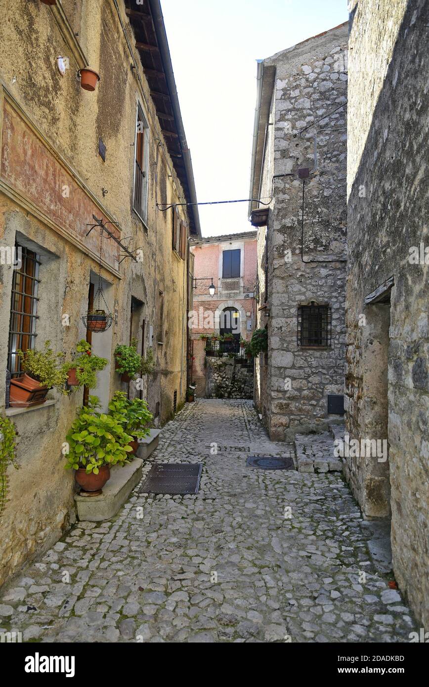 A narrow street among the old houses of Fumone, a medieval village in ...