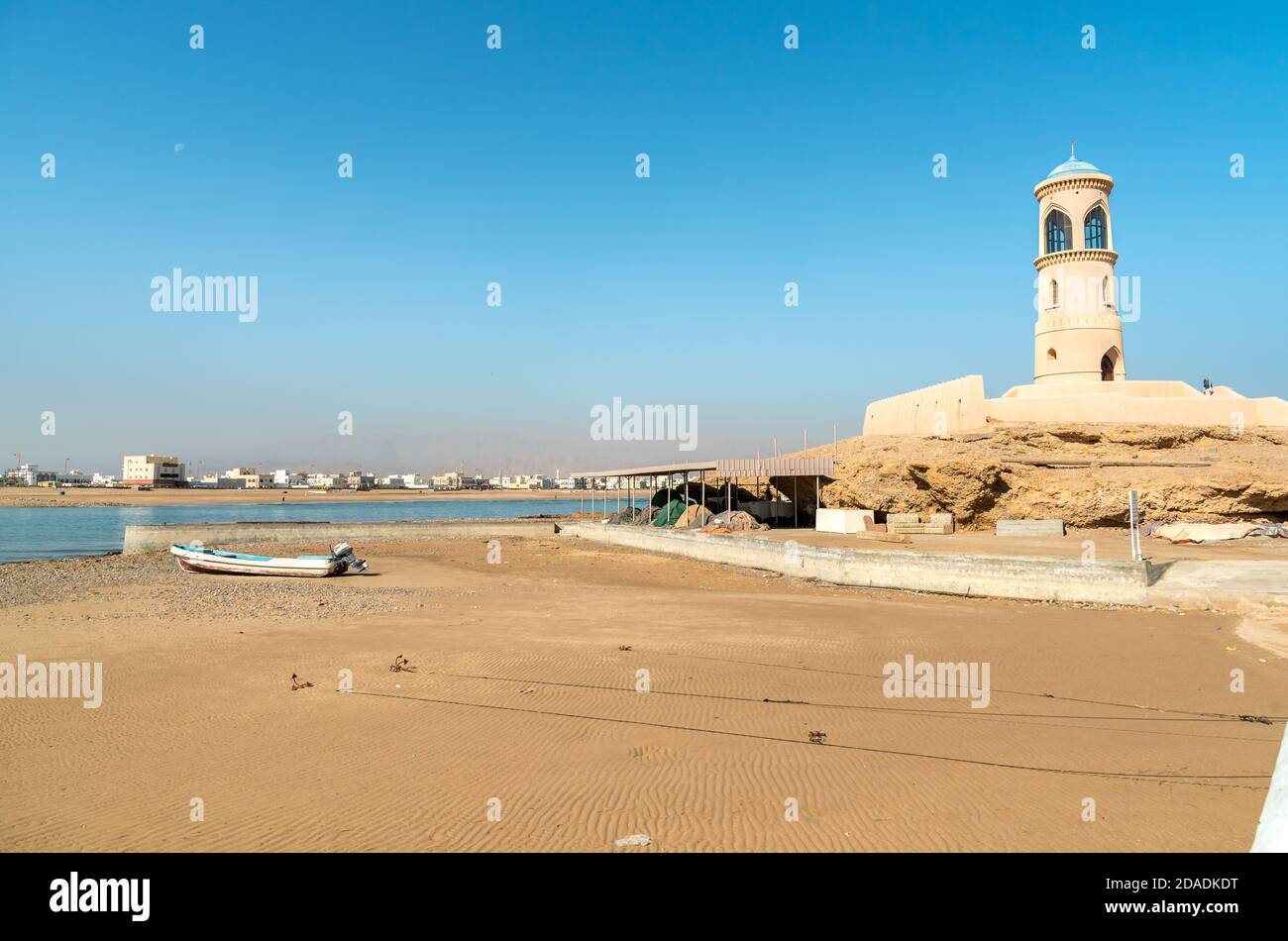 View of Al Ayjah Lighthouse with fish boat on the beach in Sur ...