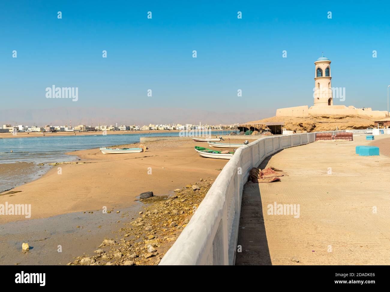 Landscape of Sur with Al Ayjah Lighthouse with fish boats on the beach ...