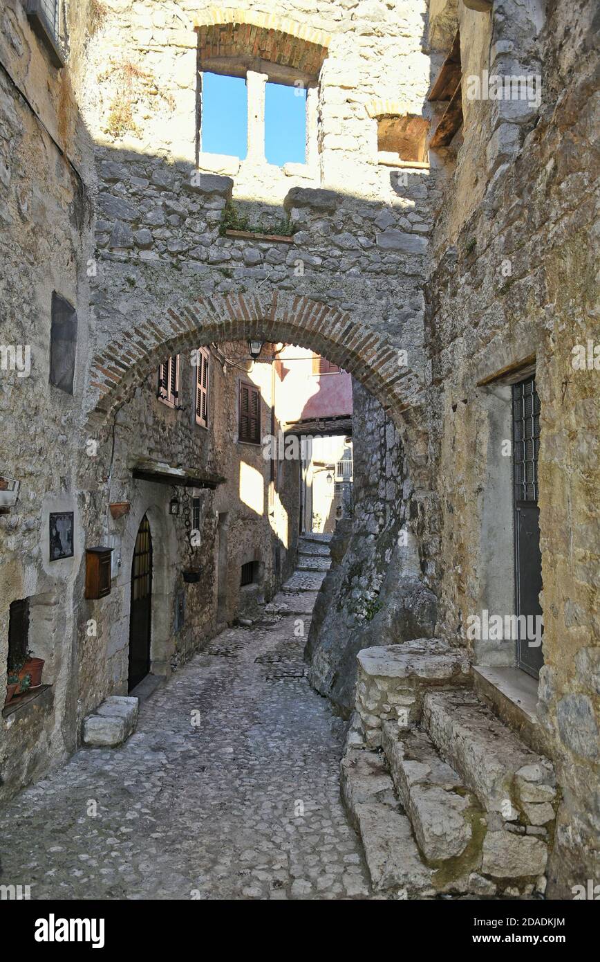 A narrow street among the old houses of Fumone, a medieval village in ...