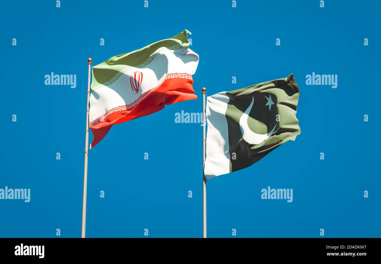 Beautiful national state flags of Iran and Pakistan together at the sky ...