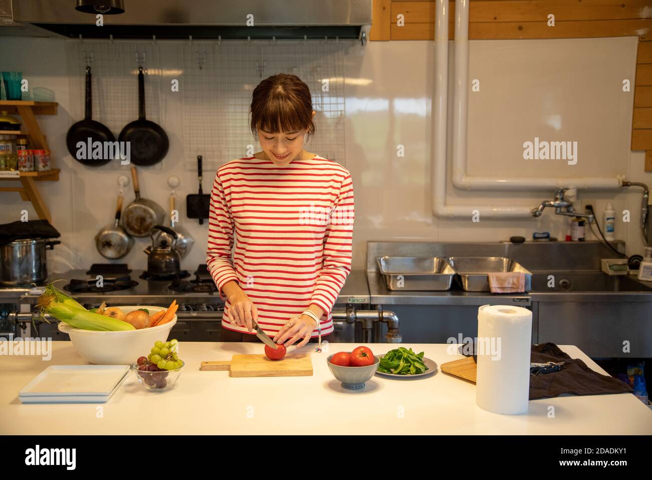 Woman Cooking in the Shared Kitchen Stock Photo - Alamy