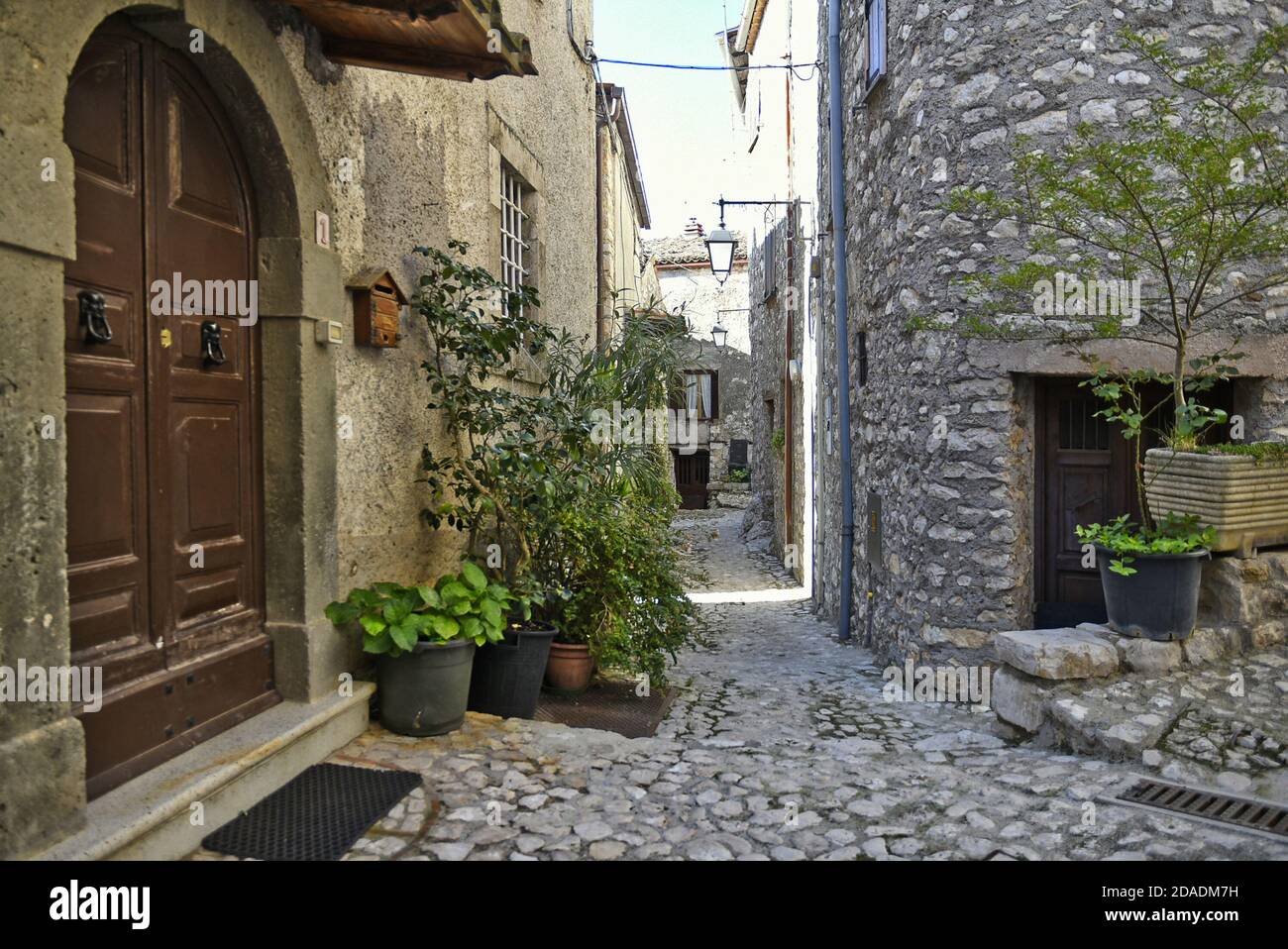 A narrow street among the old houses of Fumone, a medieval village in ...