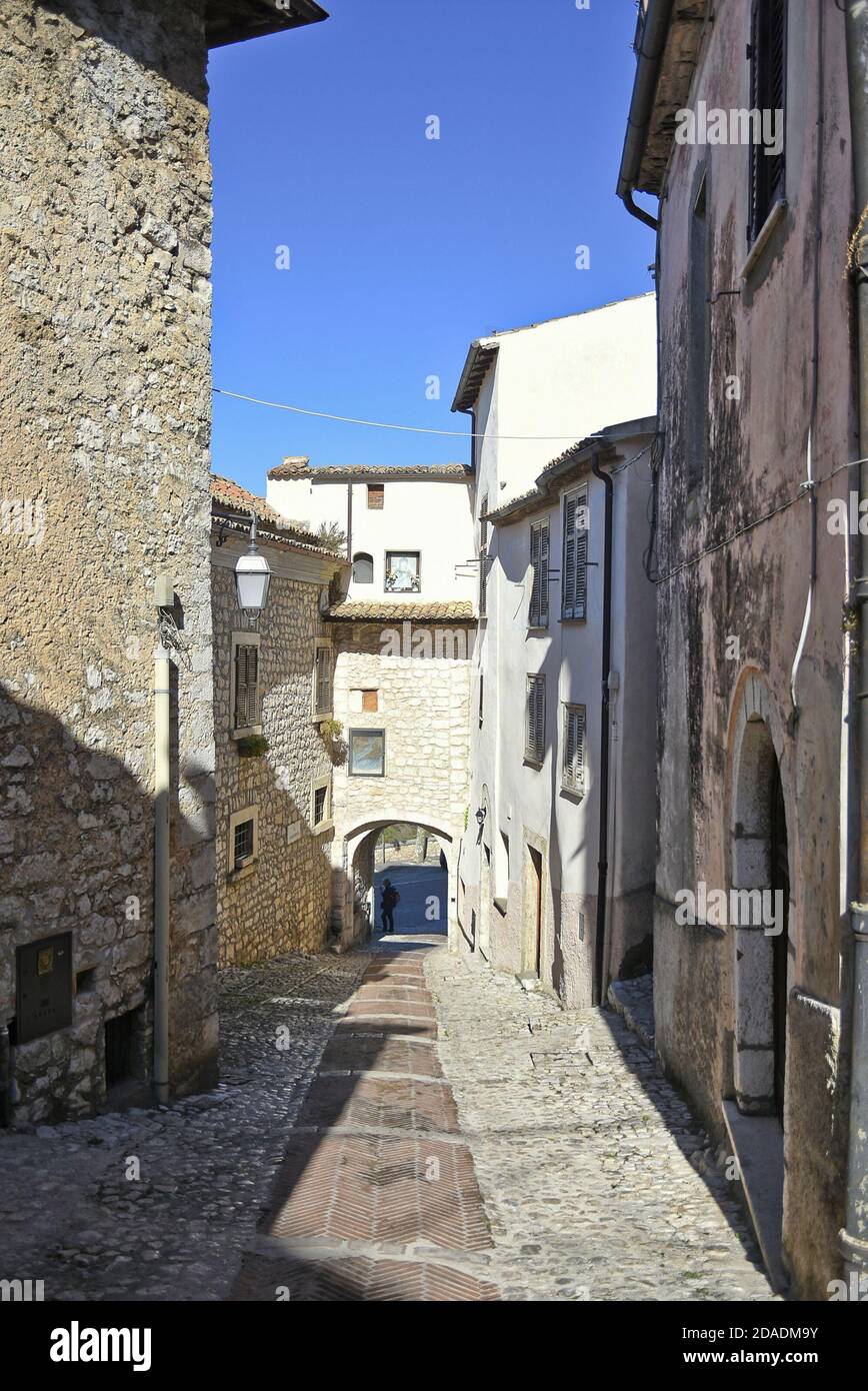 A narrow street among the old houses of Fumone, a medieval village in ...