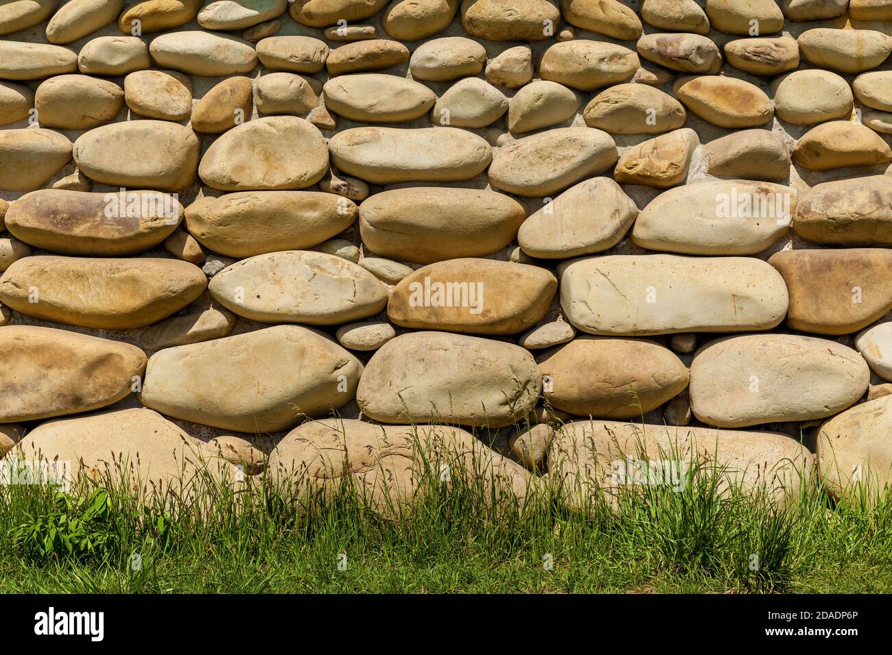 The foundation of the house is decorated with large round white stones ...