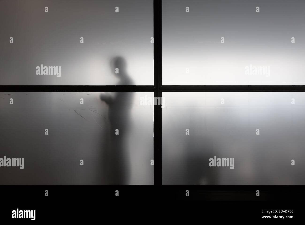 Silhouette of man behind window with matted glass Stock Photo - Alamy