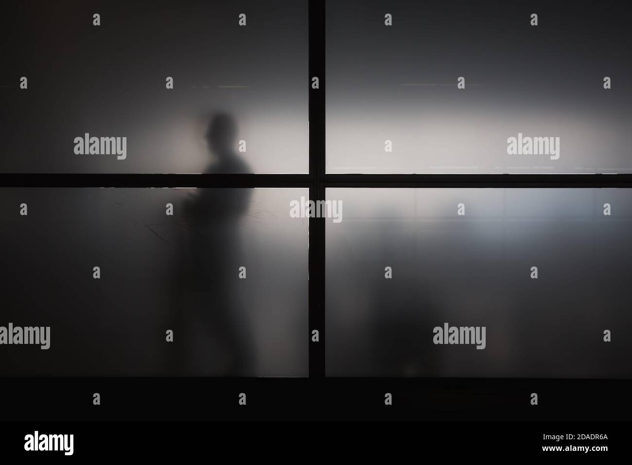 Silhouette of man behind window with matted glass Stock Photo - Alamy