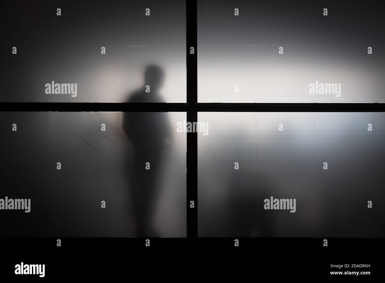 Silhouette of man behind window with matted glass Stock Photo - Alamy
