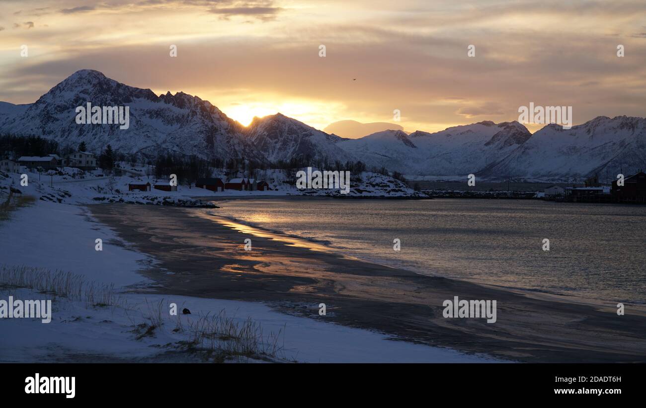 Cold winter landscapes with snow capped mountains during sunset on ...