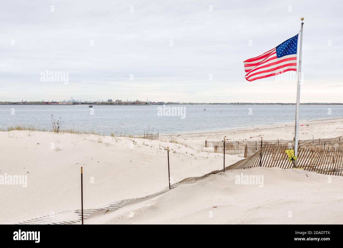 American flag on the beach of Breezy Point. Breezy Point is a ...