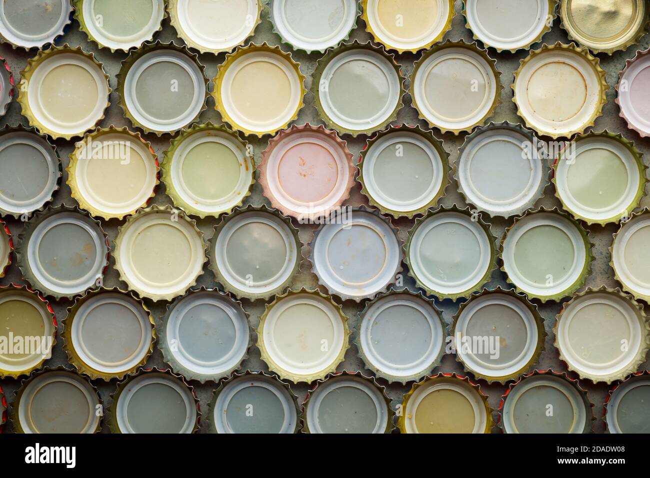 Collection of bottle caps on a stone table Stock Photo - Alamy