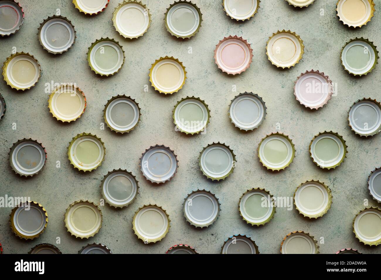 Collection of bottle caps on a stone table Stock Photo - Alamy