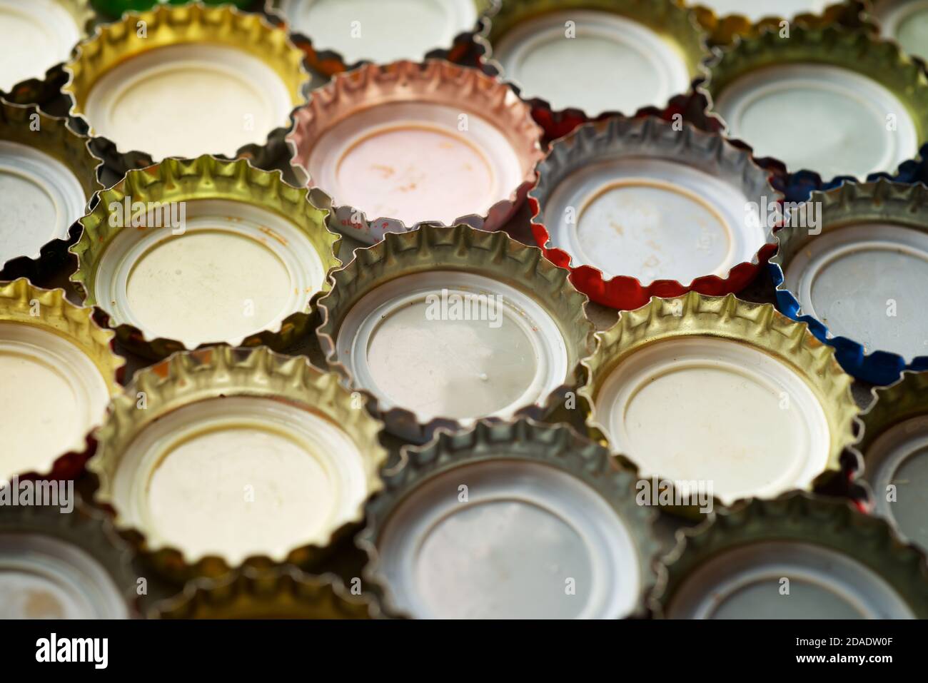 Collection of bottle caps on a stone table Stock Photo - Alamy