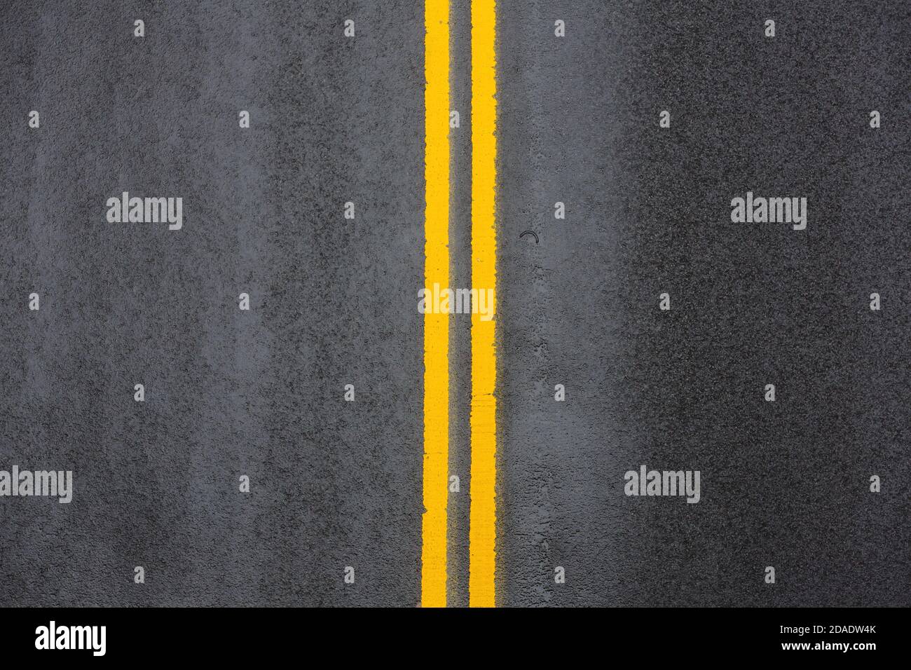 Yellow double solid line. Road markings on asphalt on the street of ...