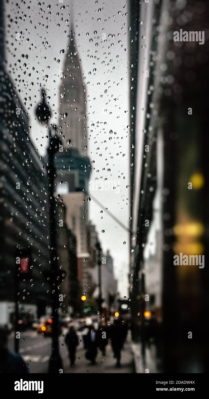 Chrysler Building on an overcast evening. Blurred New York City street ...