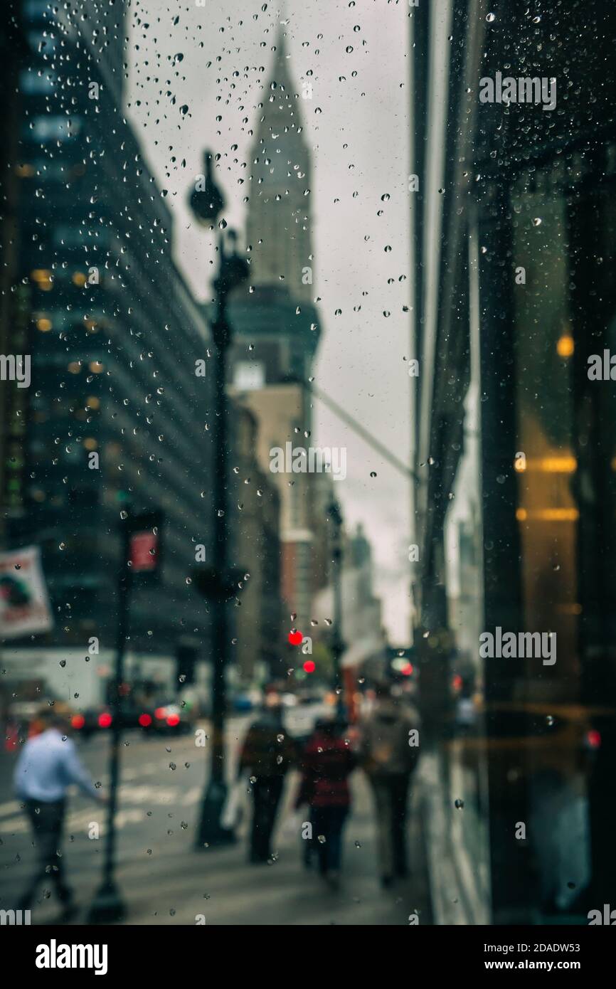 Chrysler Building on an overcast evening. Blurred New York City street ...