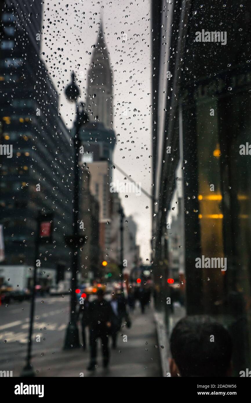 Chrysler Building on an overcast evening. Blurred New York City street ...