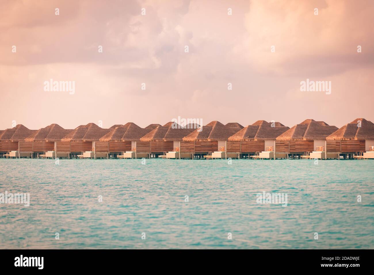 Sunset on Maldives island, luxury water villas resort and wooden pier ...