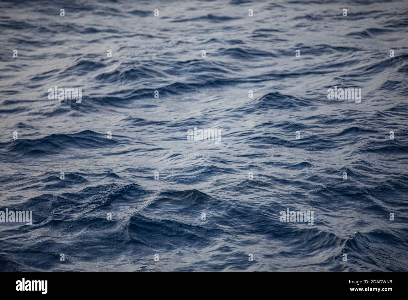 Blue sea surface with light waves. Background texture of a calm deep ...
