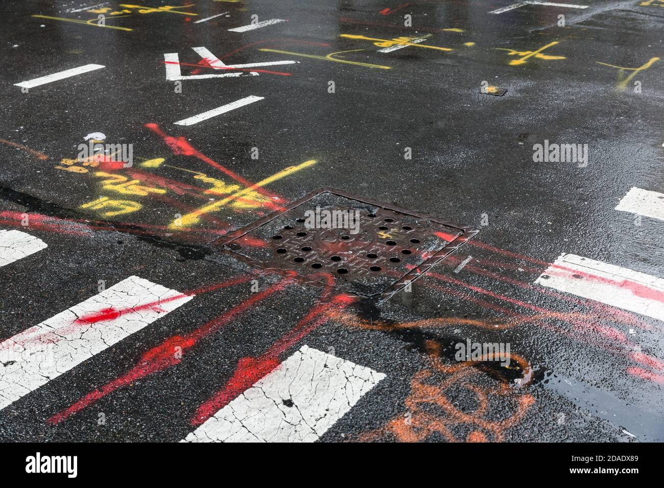 Wet asphalt with road markings and paint spots in Manhattan, New York ...