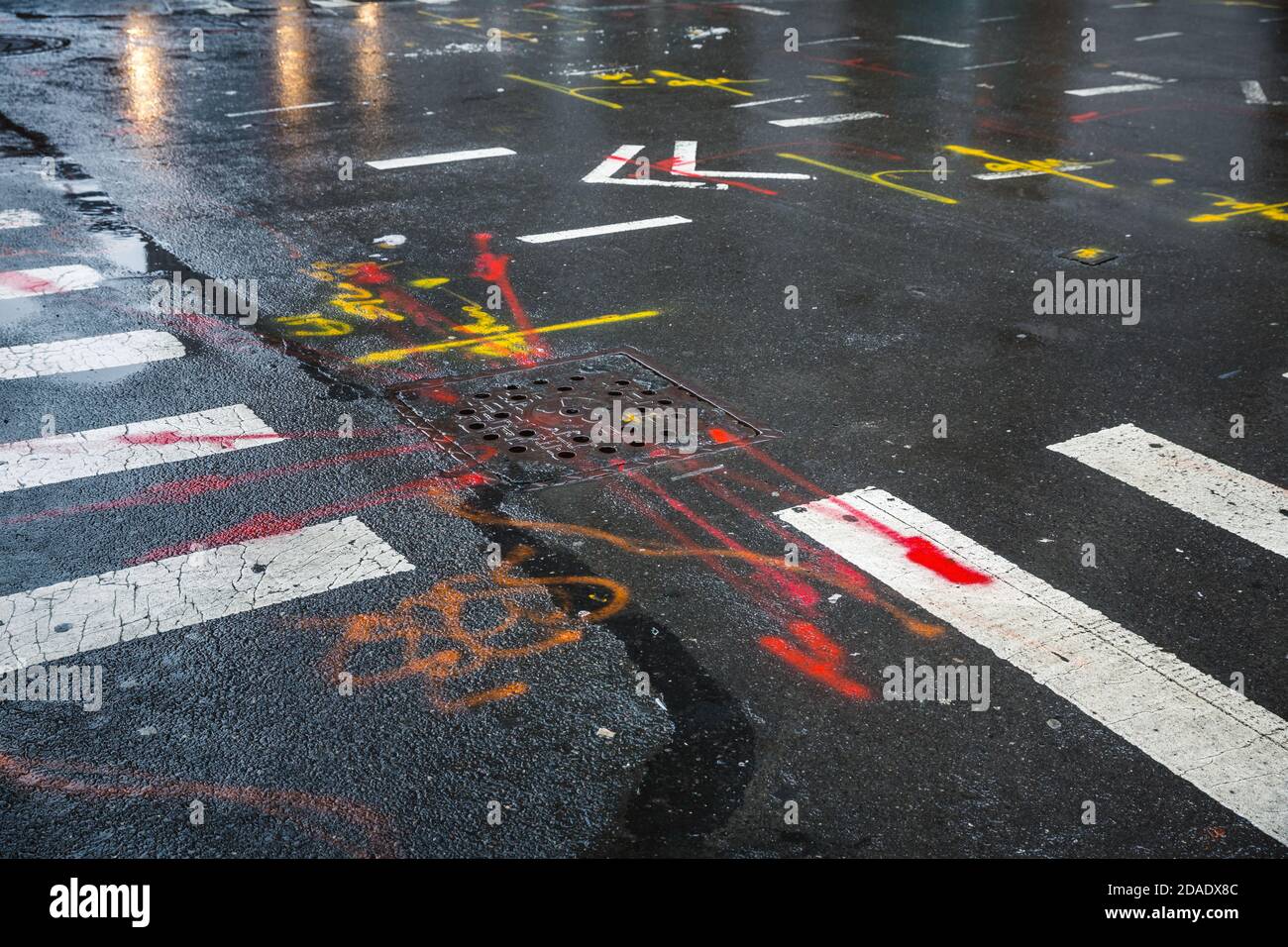 Wet asphalt with road markings and paint spots in Manhattan, New York ...