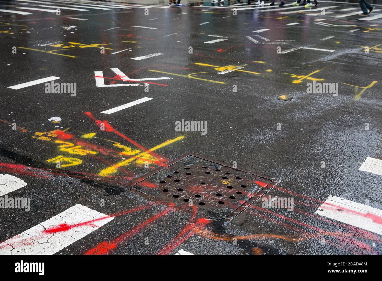 Wet asphalt with road markings and paint spots in Manhattan, New York ...