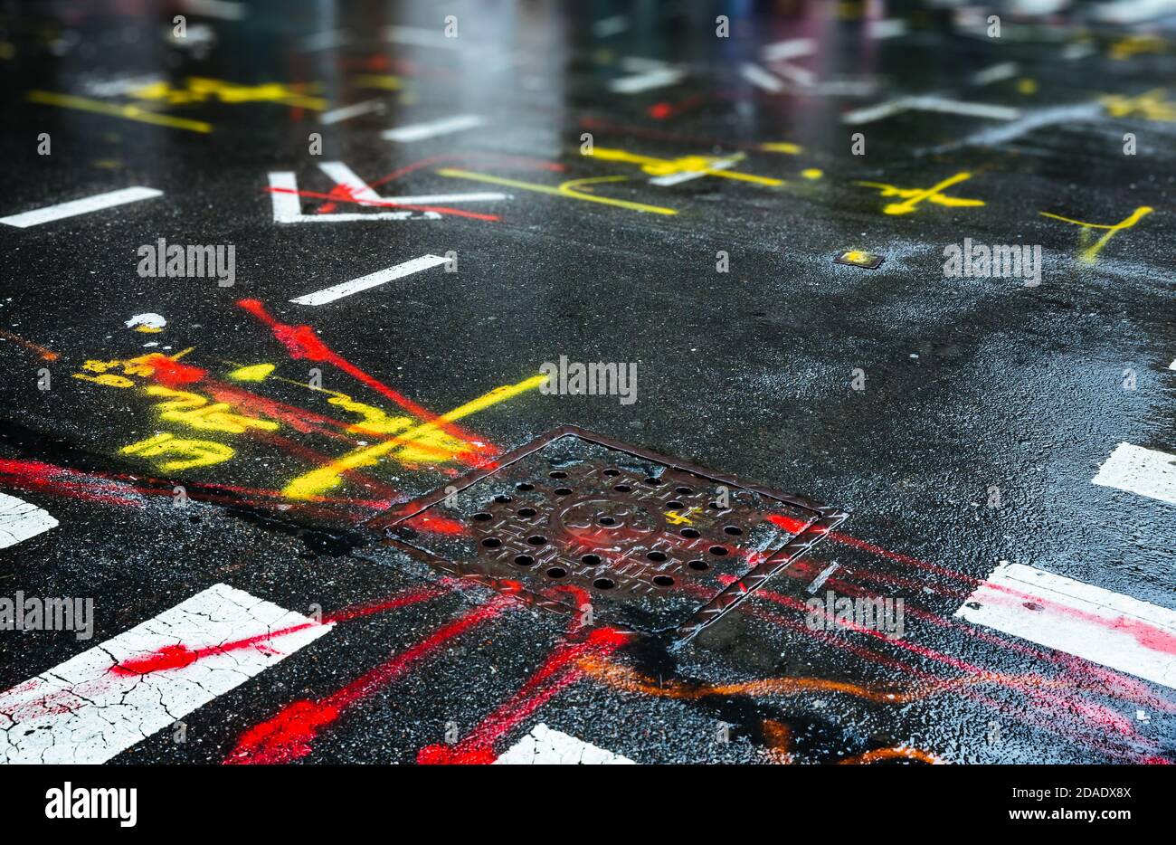 Wet asphalt with road markings and paint spots in Manhattan, New York ...