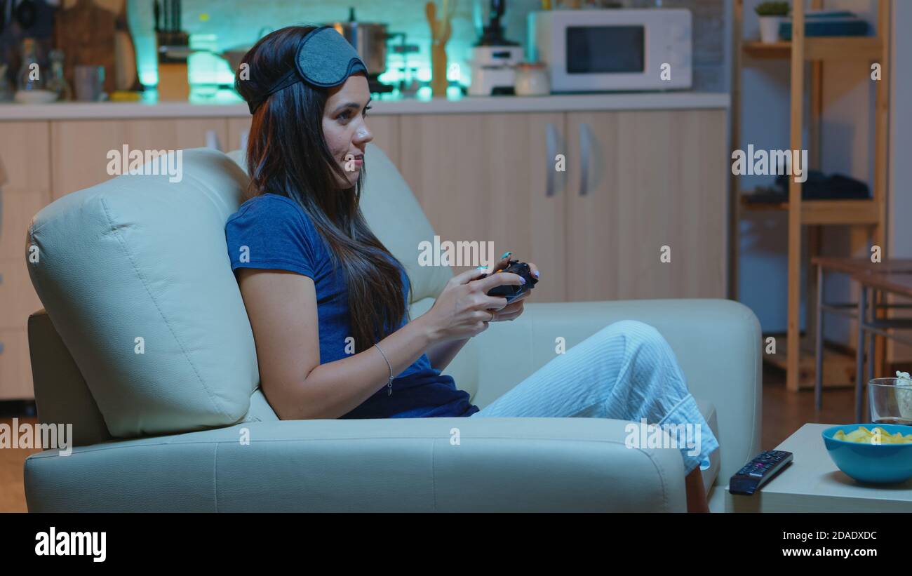 Gamer woman playing video games on console using controller and ...