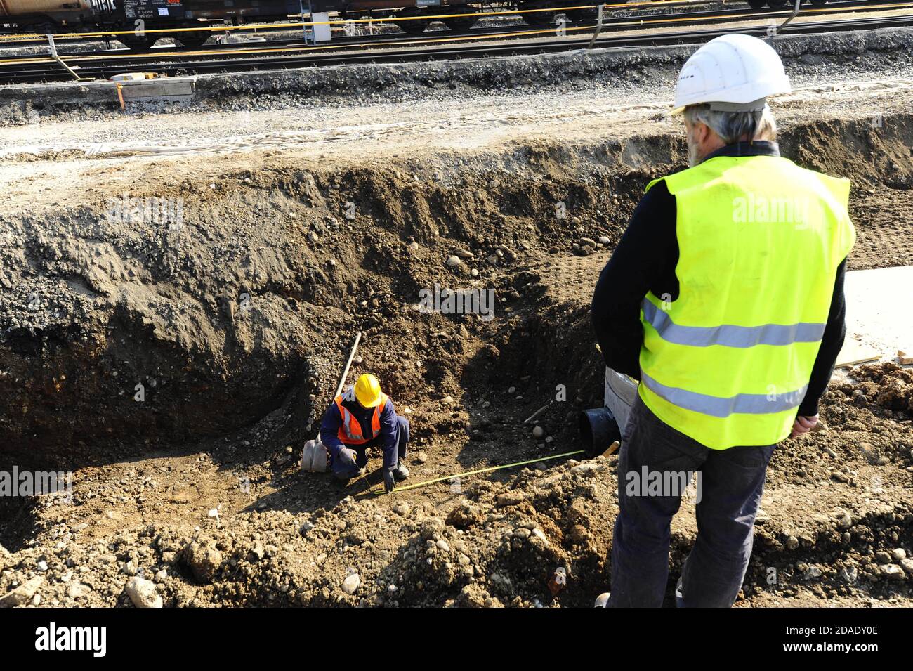 two workers at the construction site of sewer construction and ...
