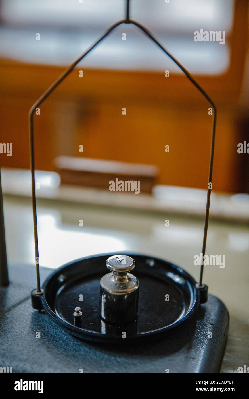 Closeup vertical shot of an old laboratory scale for experiments with a ...