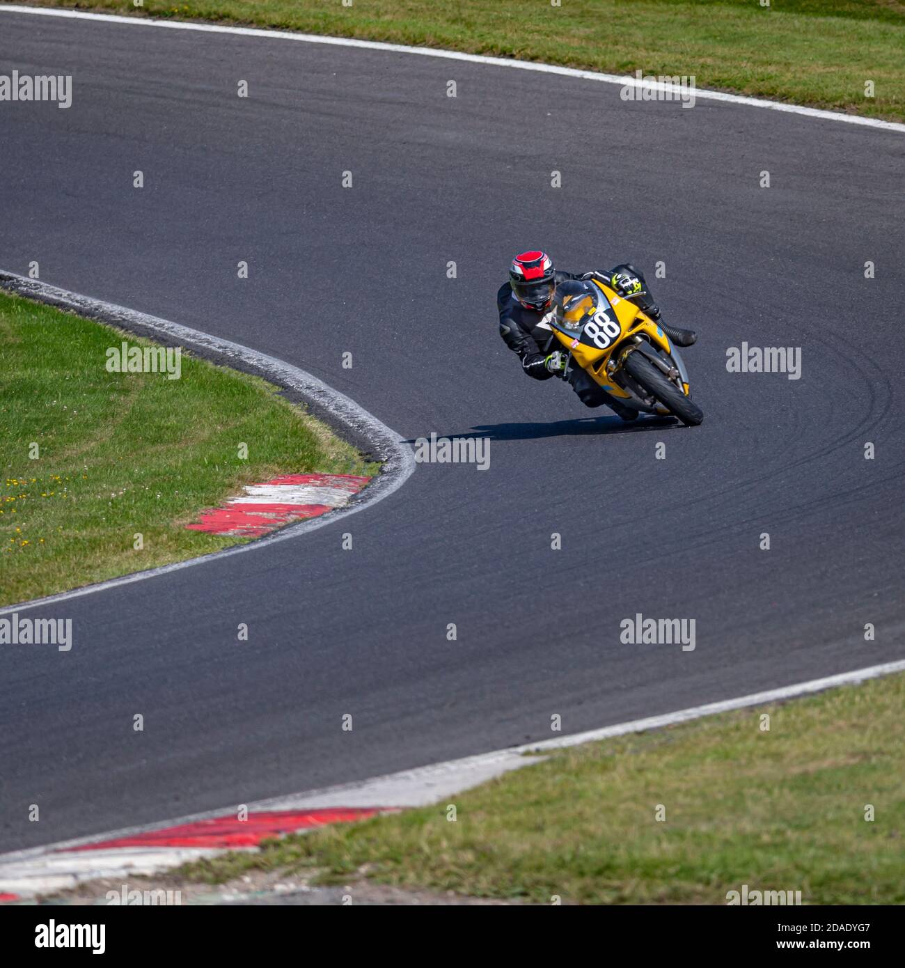 A shot of a racing bike cornering on a track Stock Photo - Alamy