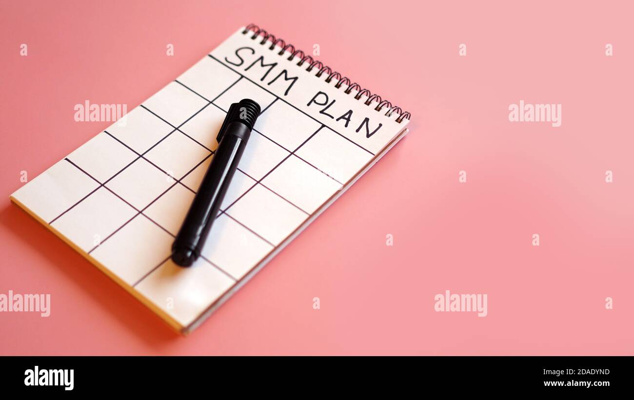 Social media marketing concept - SMM plan in a notebook on a pink ...
