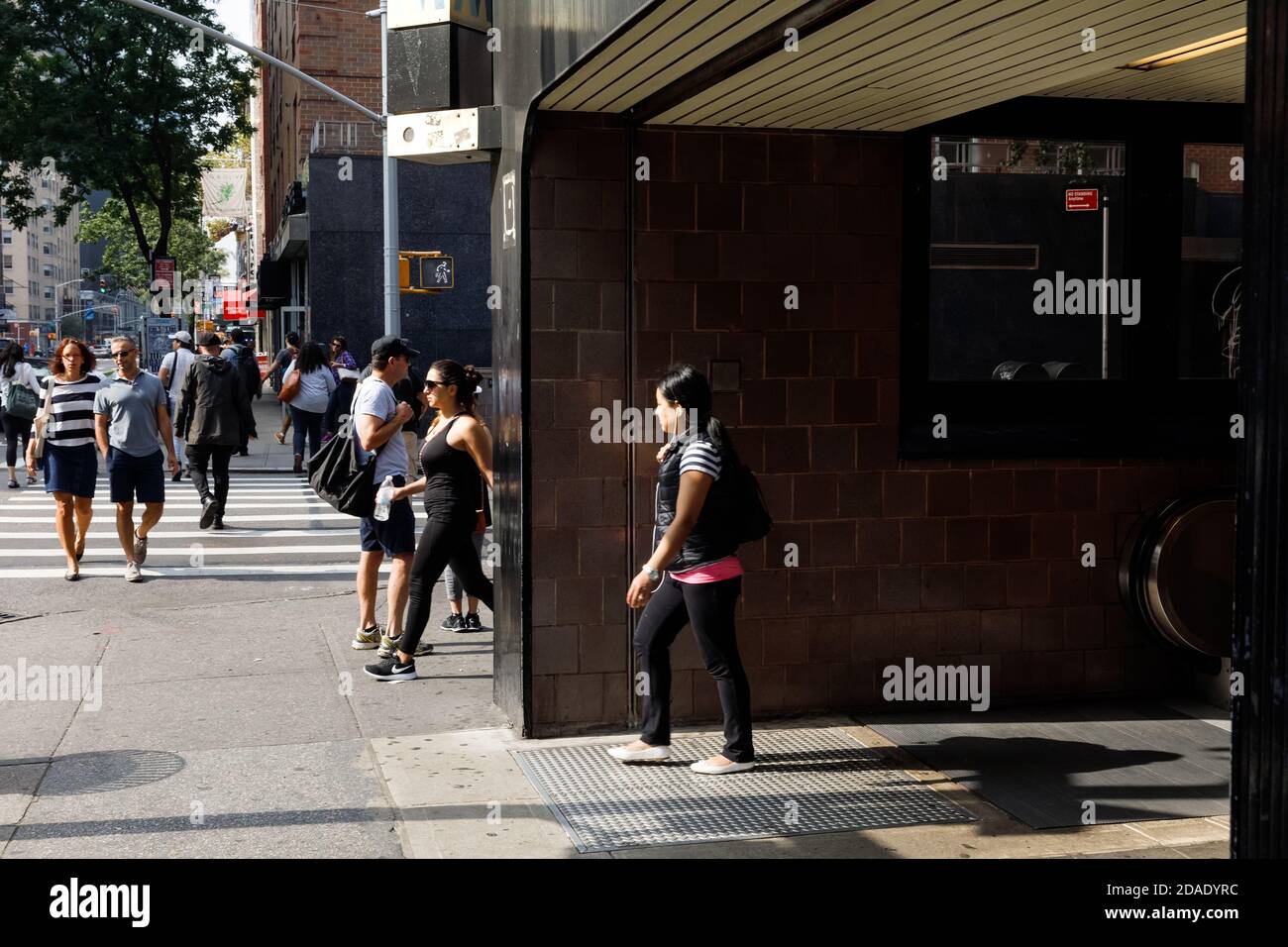 NEW YORK, USA - Sep 16, 2017: Manhattan street scene. People walk out ...
