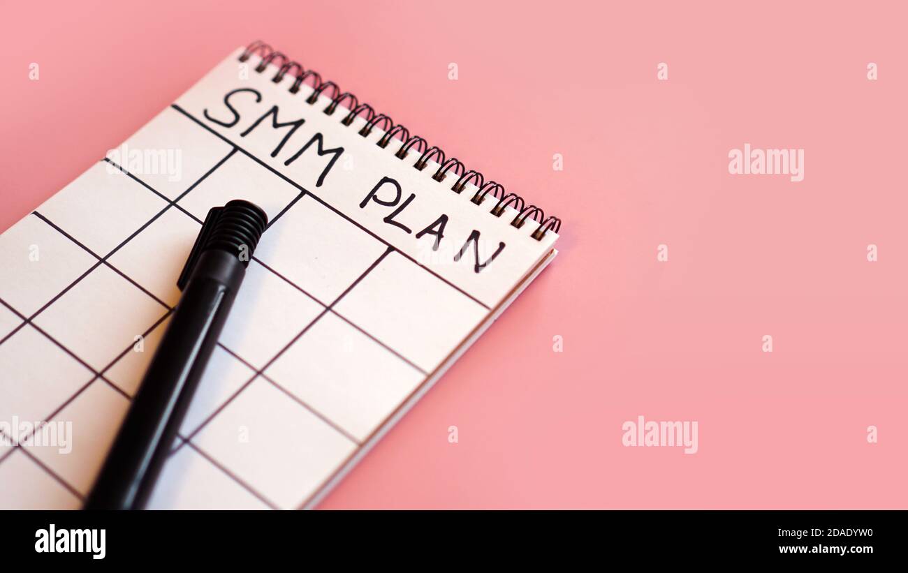 Social media marketing concept - SMM plan in a notebook on a pink ...