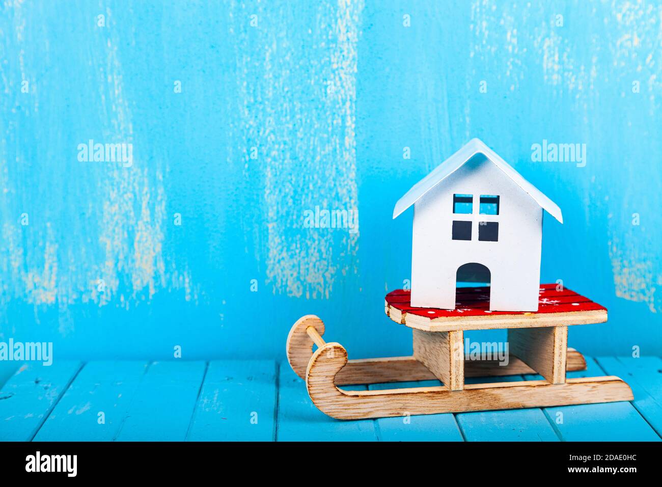 House is on a sled. Buying a property. Concept Stock Photo - Alamy