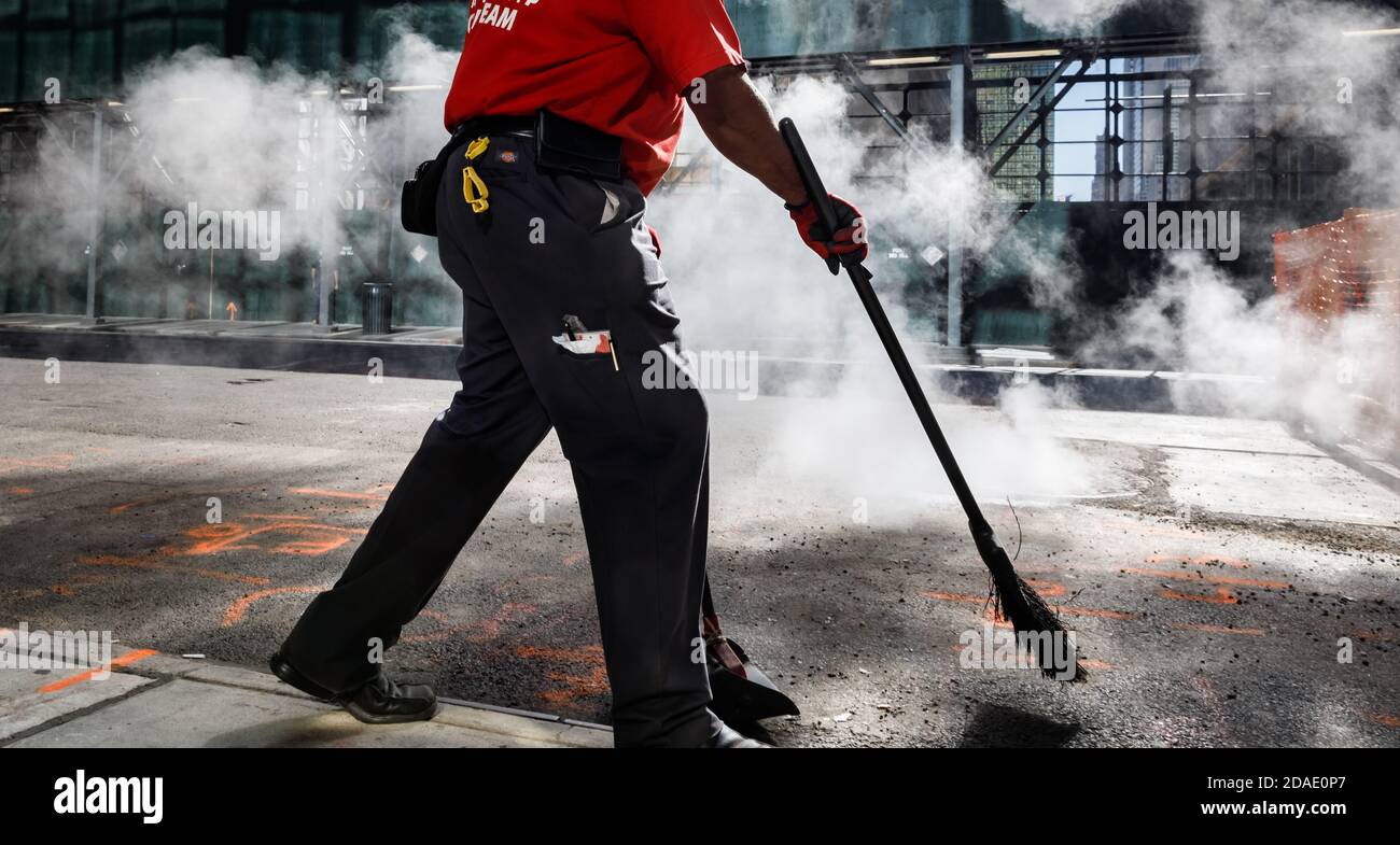 NEW YORK, USA - Sep 23, 2017: Manhattan street scene. Cleaner sweeps ...