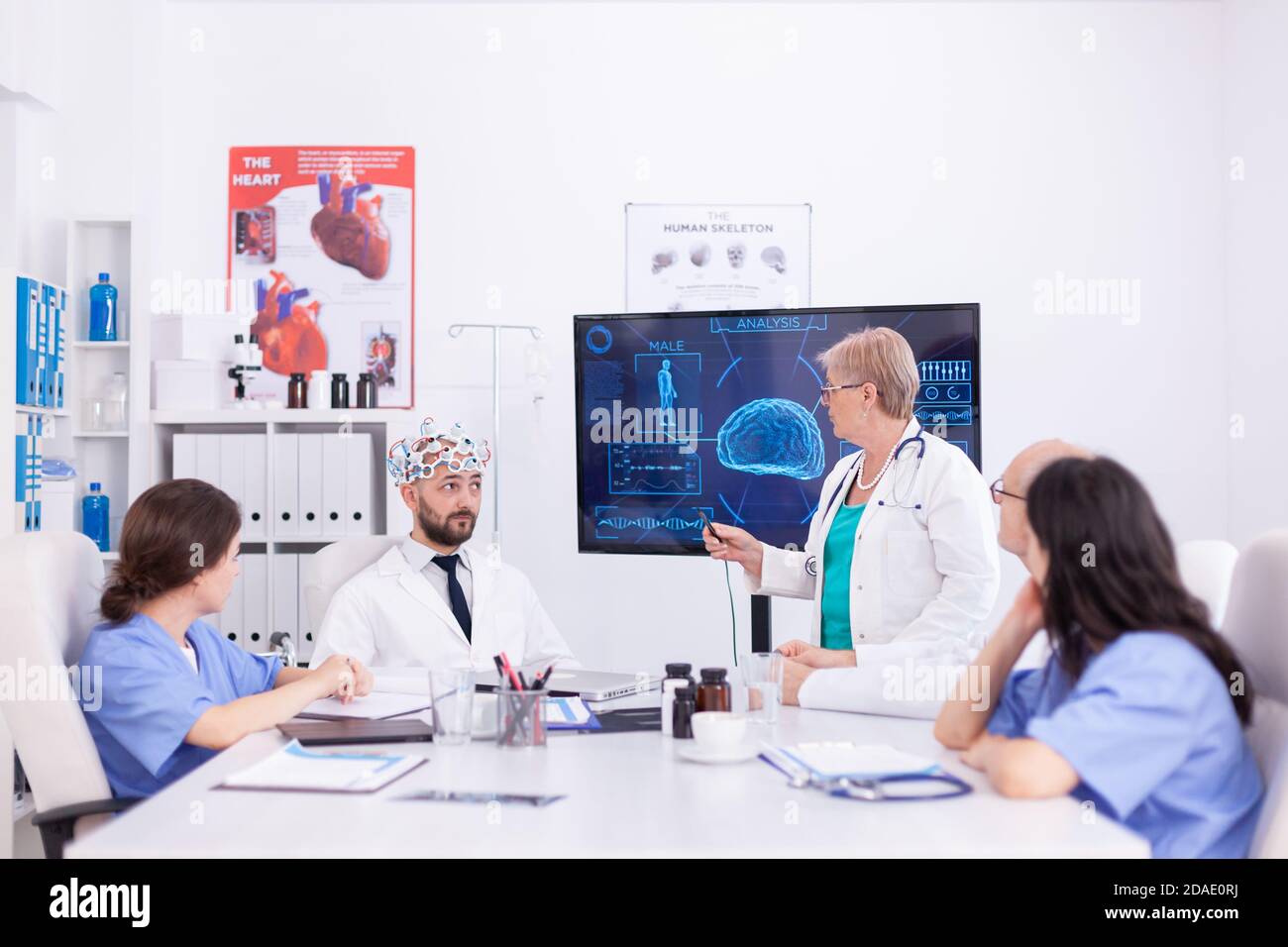Consciousness doctor wearing headset with sensors for brain waves ...