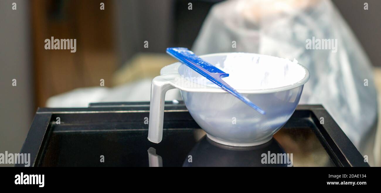 White hair dye in container on the special table in hair salon Stock ...