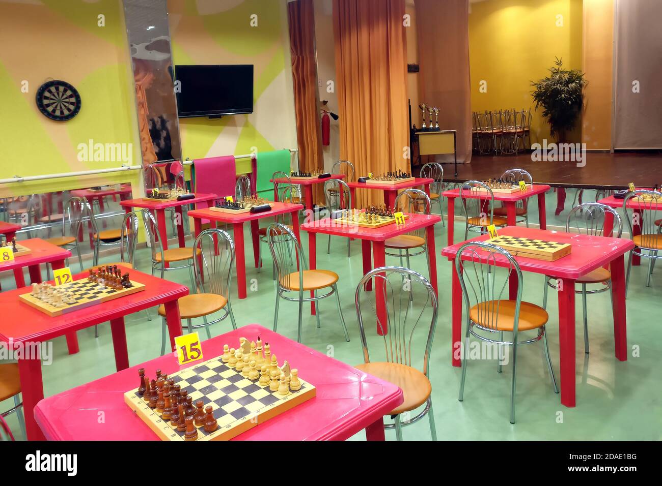 Chess tournament among children and adults. Tables with boards in the ...