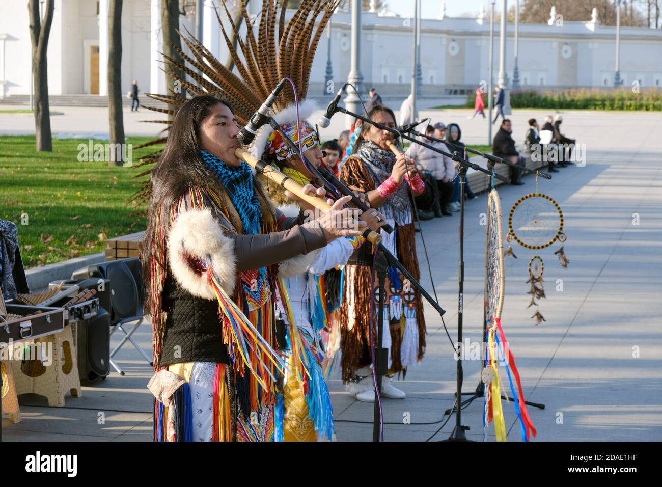 American Indians street musicians in national costumes play in a city ...