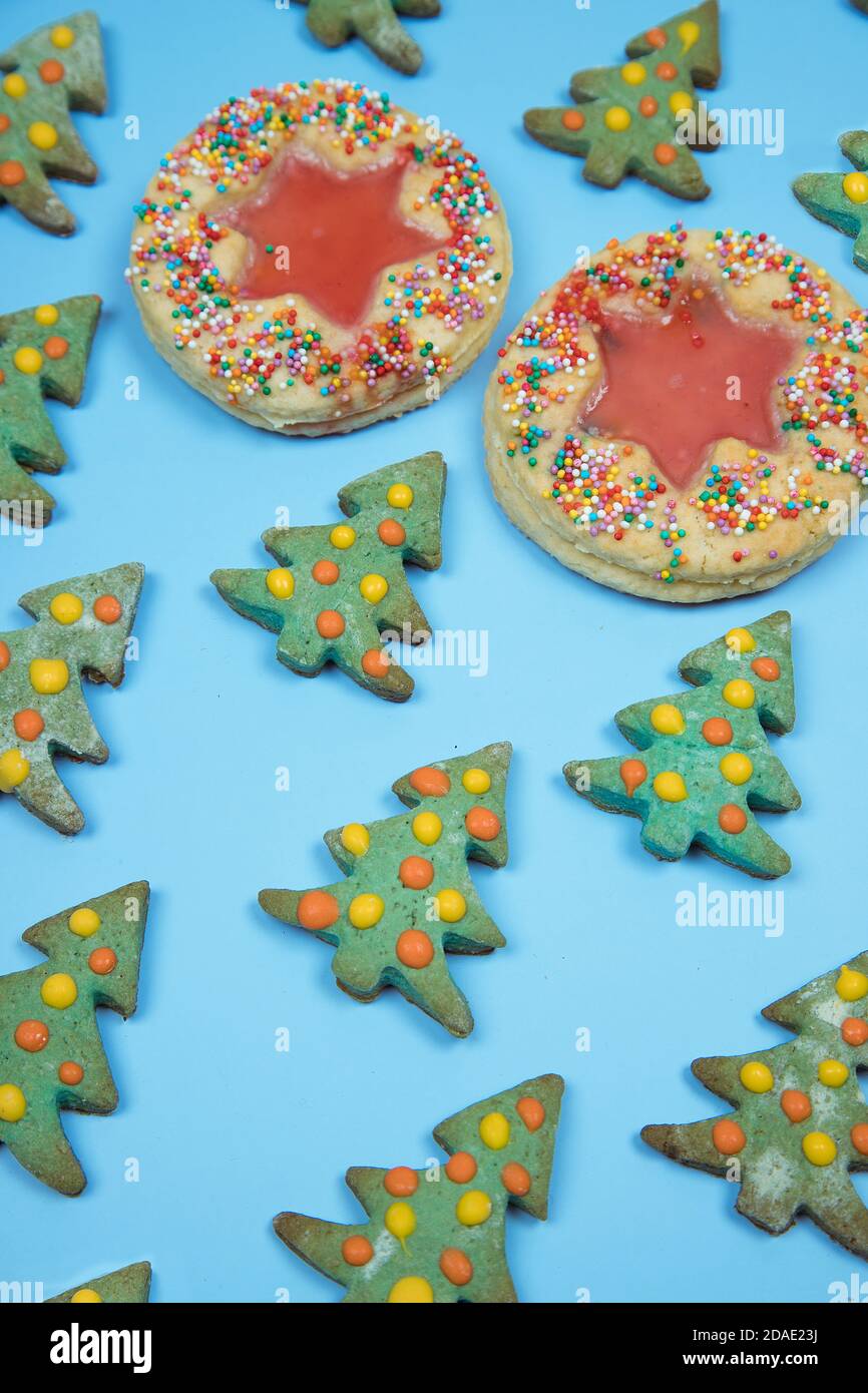 Christmas homemade cookies laid out in rows in a pattern on a blue ...