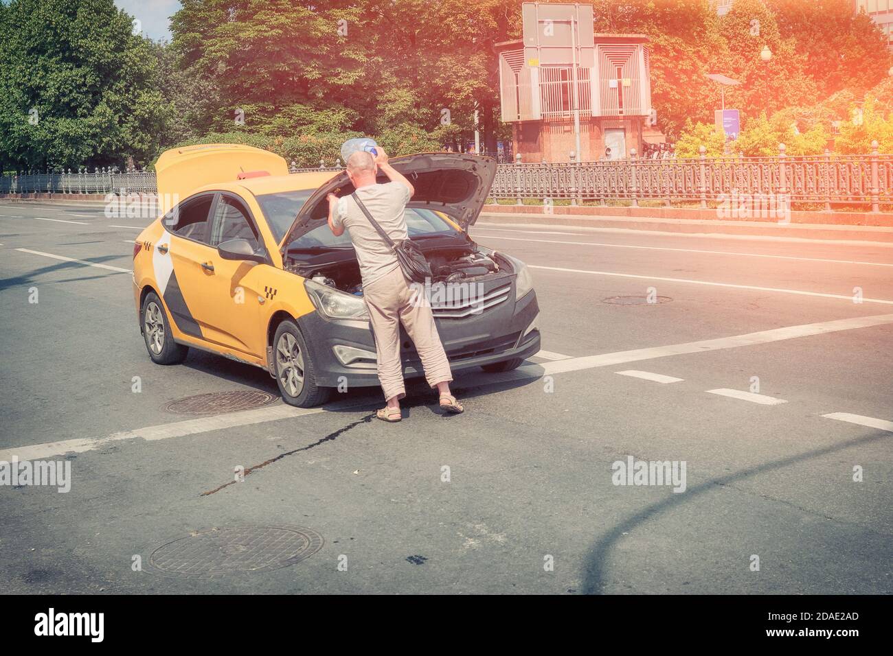 Taxi driver saves the car from overheating on a hot summer day ...