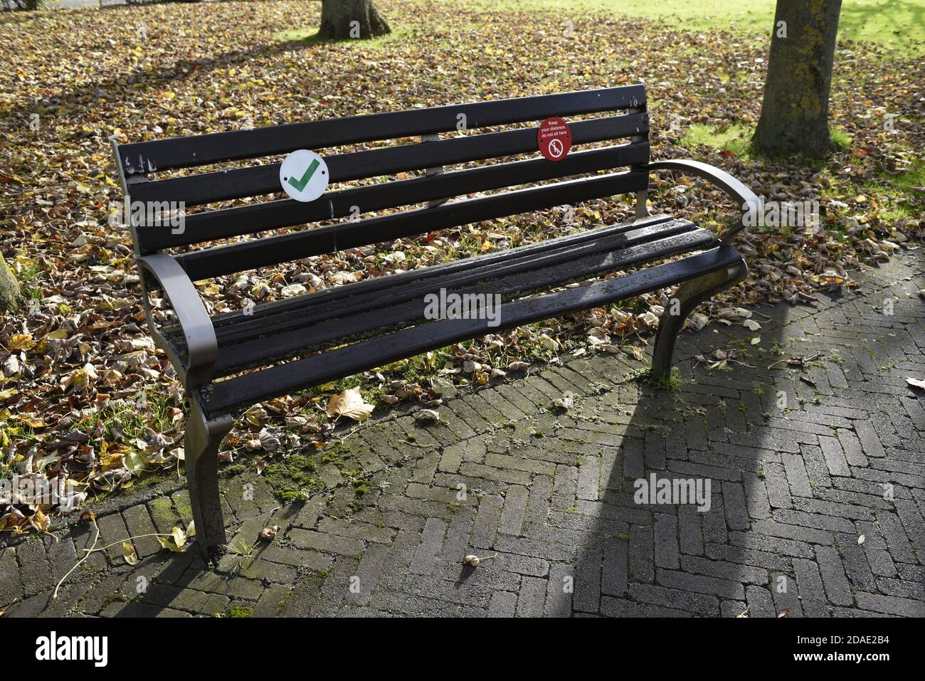 Social distancing signs on benches to encourage social distancing on ...