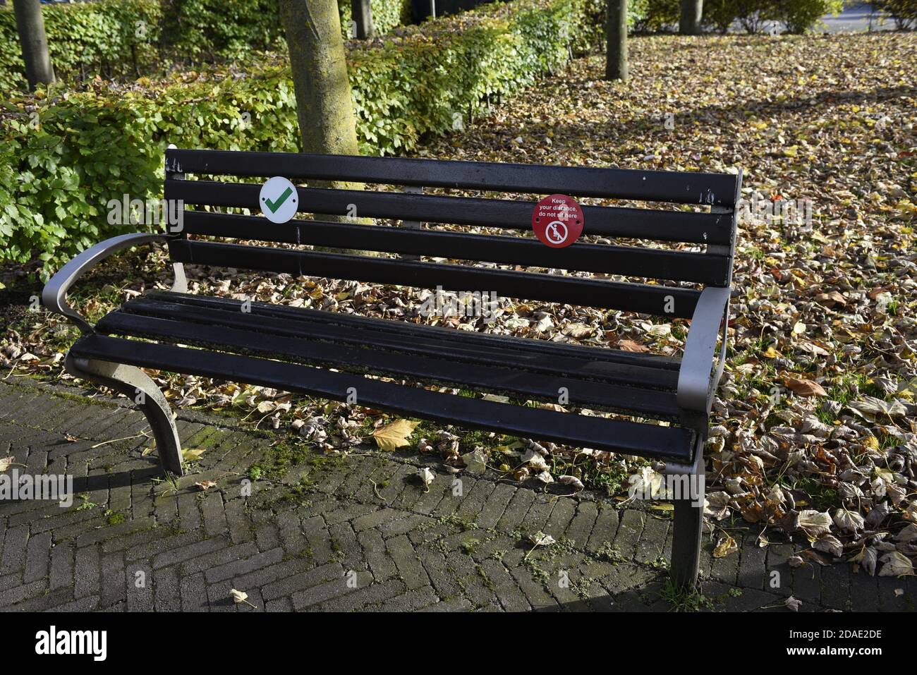 Social distancing signs on benches to encourage social distancing on ...