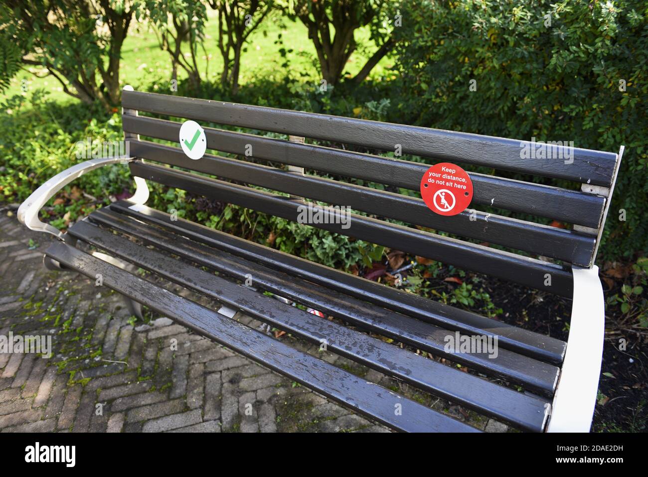 Social distancing signs on benches to encourage social distancing on ...