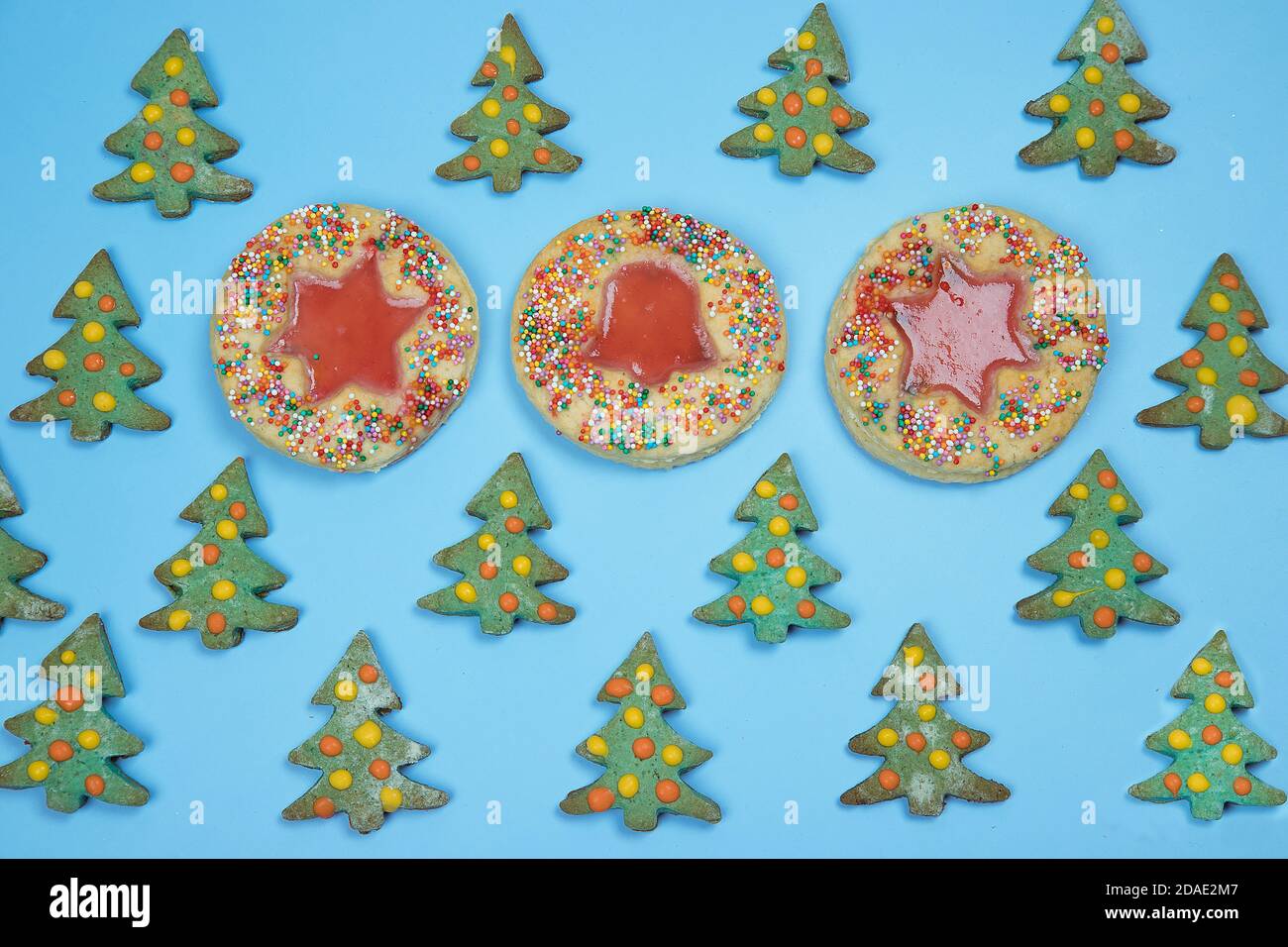 Pattern of Christmas homemade cookies laid out in rows on a blue ...