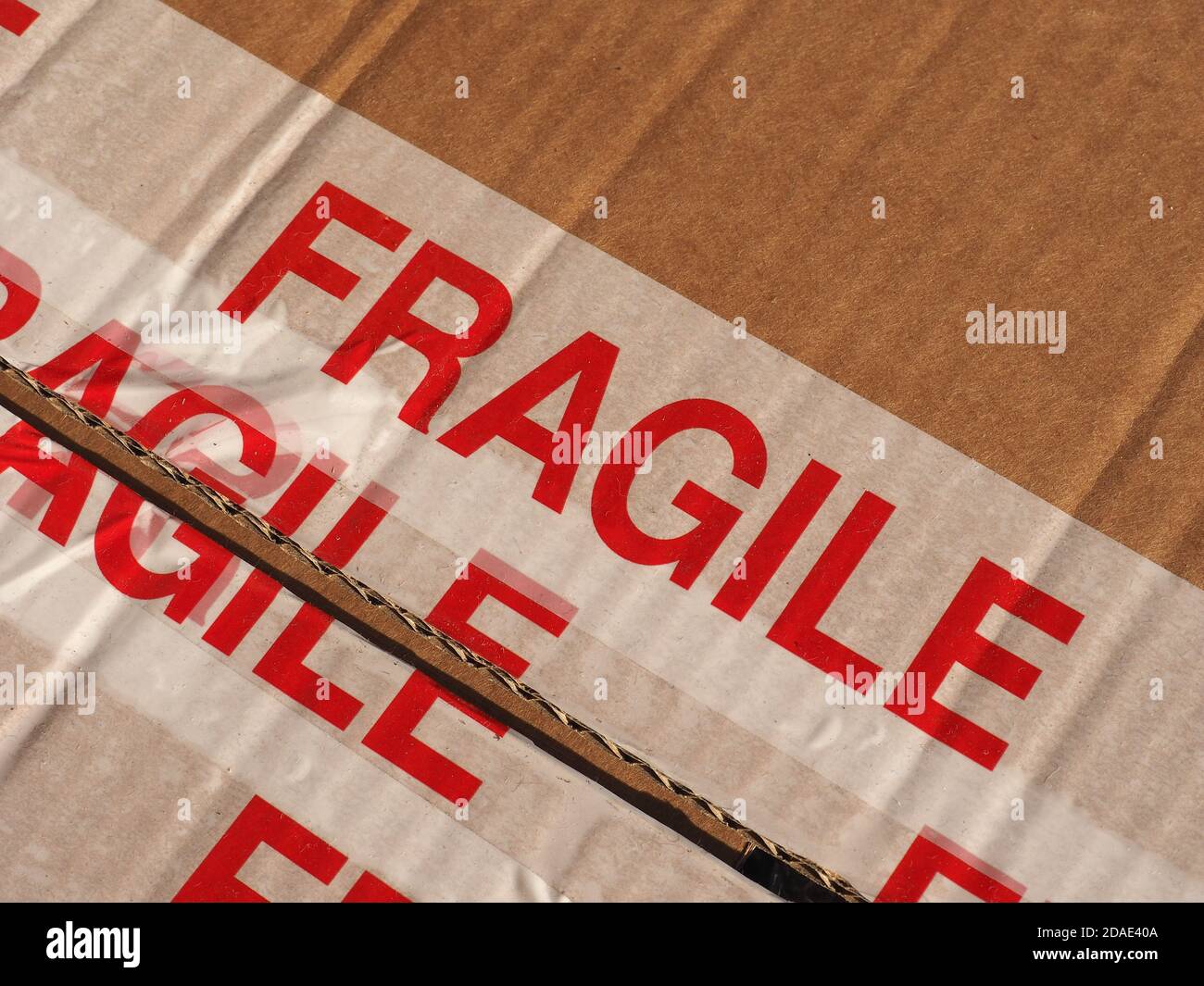 Fragile warning tape on corrugated cardboard box Stock Photo - Alamy