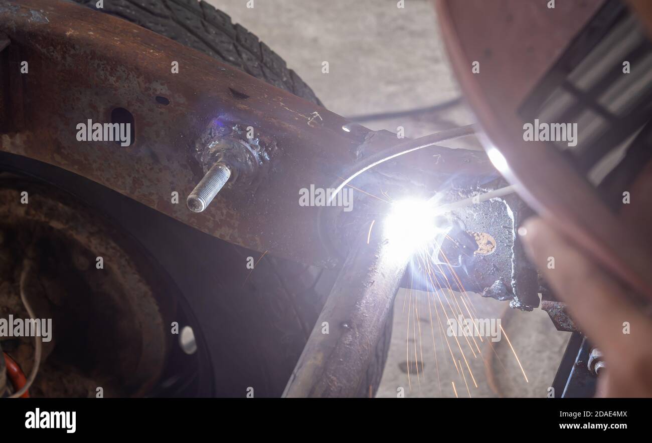 Welding Metal Pipe of Car Chassis by Welding Worker or Welder Man in ...