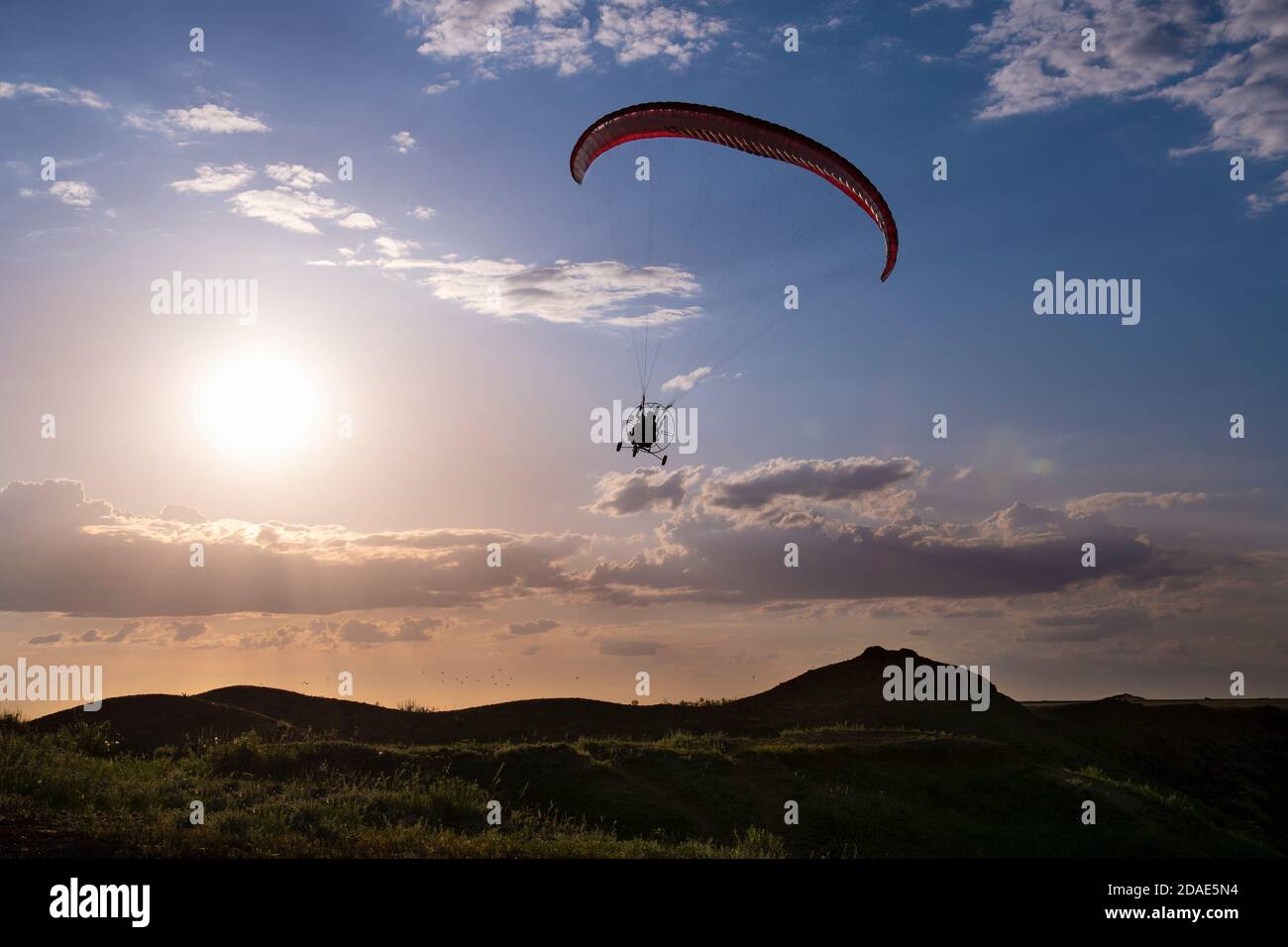 Motorized paraglider over the shore in the sky at golden hour Stock ...