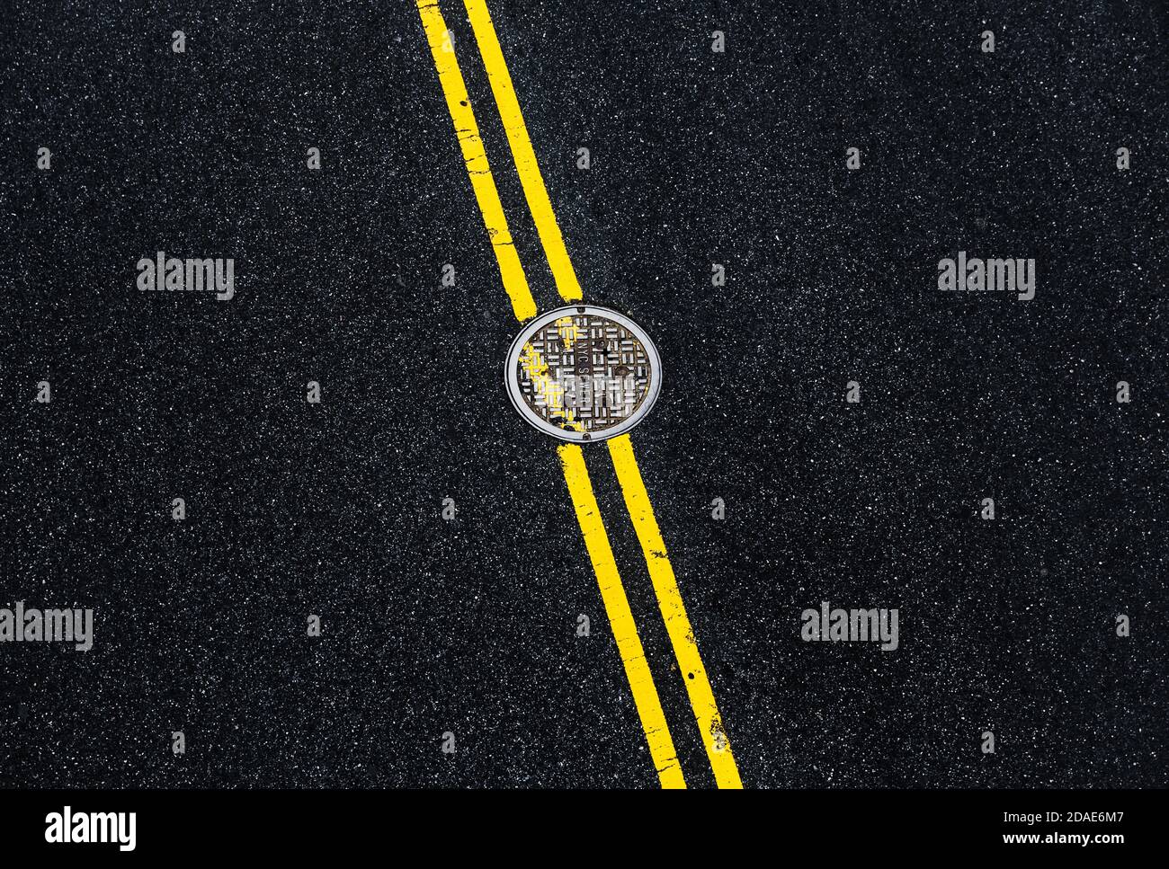 Yellow double solid line with the hatch cover. Road markings on asphalt ...